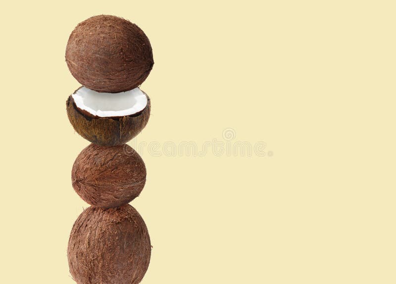 Stack of Fresh Coconuts on Beige Background. Space for Text Stock Photo ...