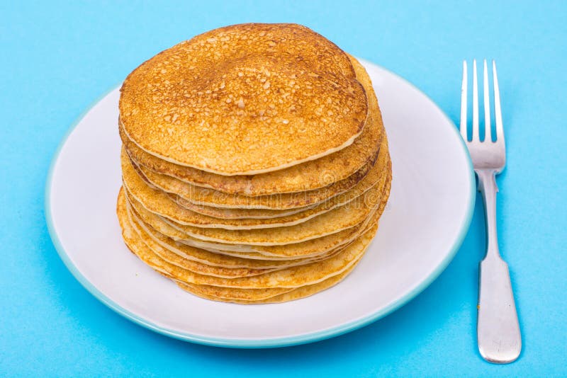 Stack of Fresh Delicious Pancakes on White Plate on Blue Background ...