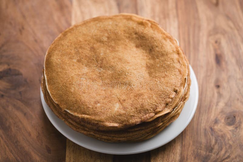 Stack of Fresh Hot Crepes or Blinis on Wood Table Stock Photo - Image ...