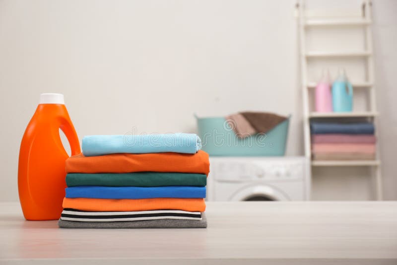 Stack of Fresh Laundry and Detergent on White Table in Bathroom Stock ...