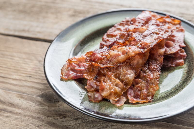 Stack of Fried Bacon Strips on the Plate Stock Photo - Image of ...