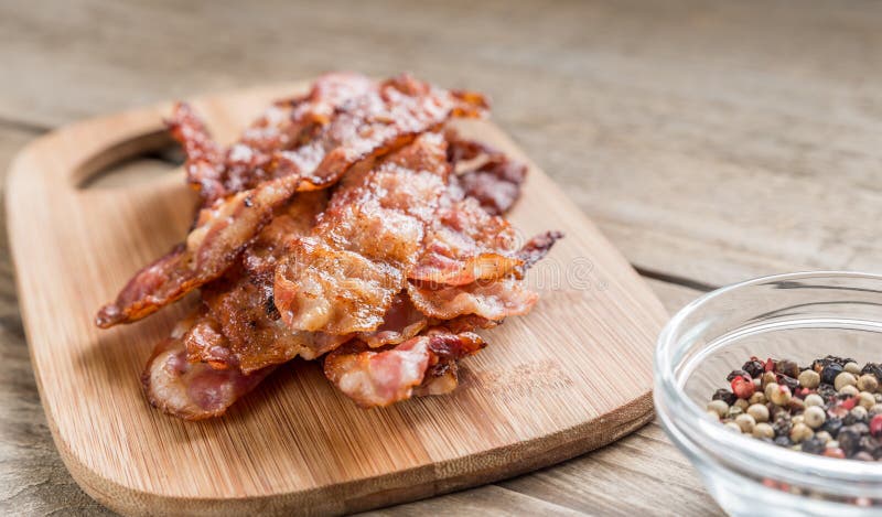 Stack of Fried Bacon Strips on the Wooden Board Stock Photo - Image of ...