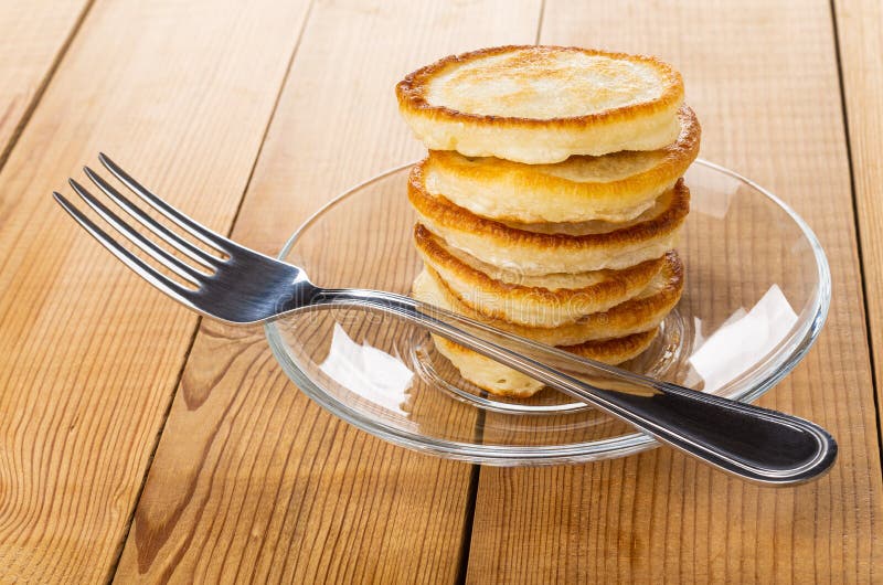 Stack of Fried Pancakes, Fork on Saucer on Wooden Table Stock Image ...