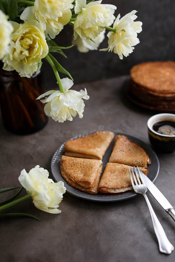 A Stack of Fried Rice Pancakes on a Table with Tulips. Stock Photo ...