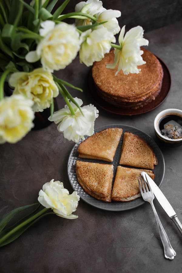A Stack of Fried Rice Pancakes on a Table with Tulips. Stock Photo ...