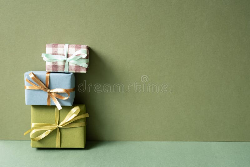 Stack of Gift Box on Green Table. Khaki Wall Background Stock Image ...