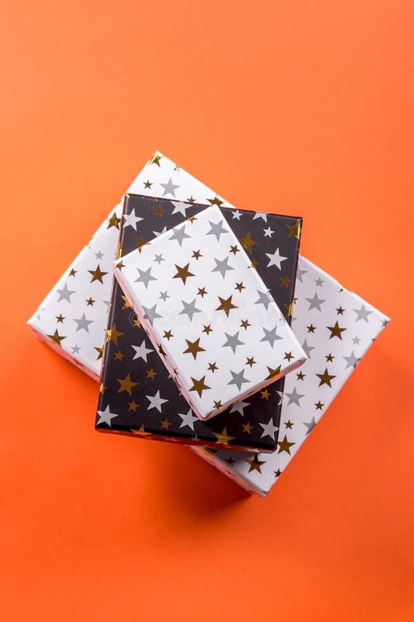 Stack of Gift Boxes with Stars on Orange Stock Photo - Image of ...