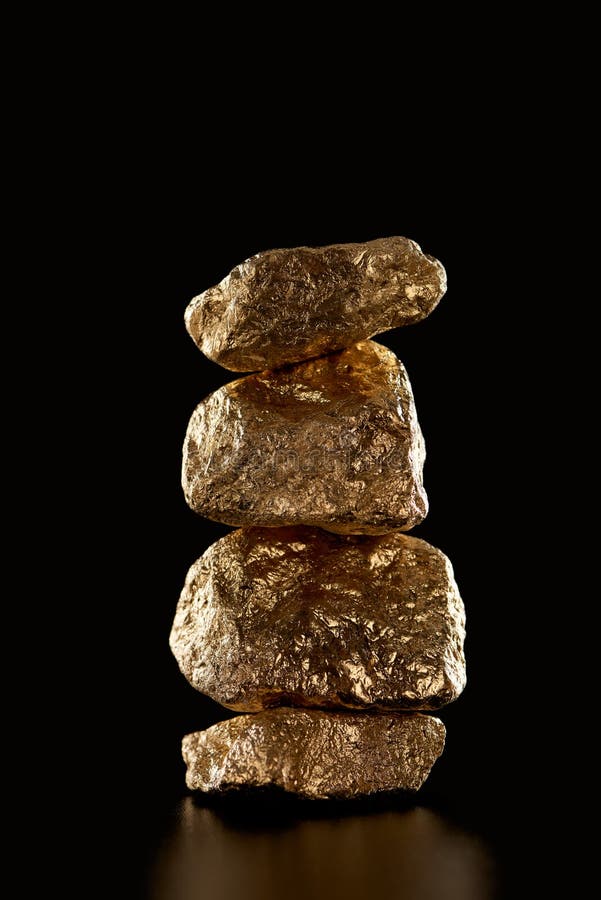 Stack of Gold Textured Shiny Stones Isolated on Black. Stock Photo ...