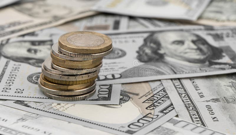 Stack of Golden Coins on Dollar Bills on a Table Stock Photo - Image of ...