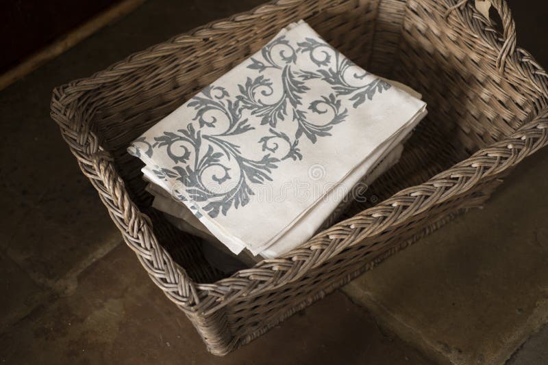 Stack of Gray Floral Design Napkins in Rectangular Woven Basket Stock ...