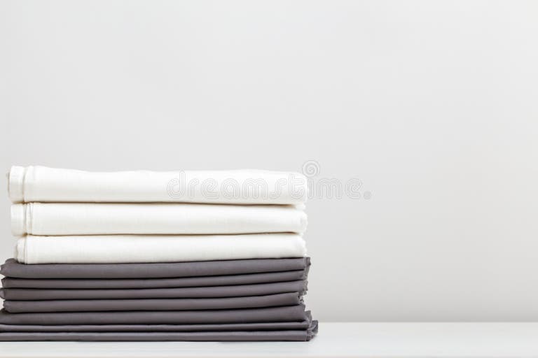 A Stack of Gray and White Bed Linens, Sheets on the Table Stock Photo ...
