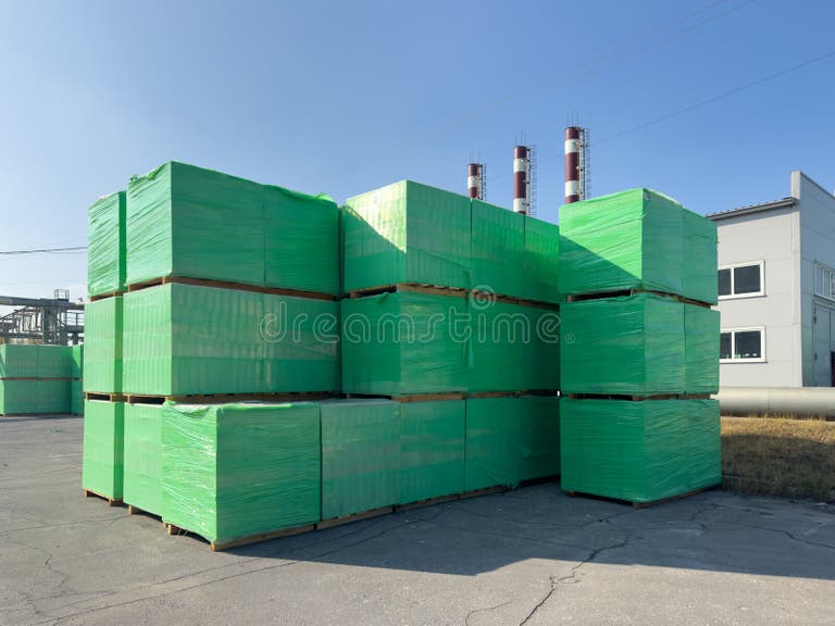 A Stack of Green Boards are Piled Up in a Field Stock Image - Image of ...