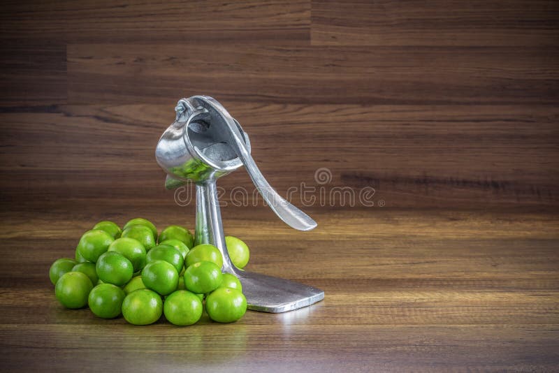 Stack of Green Lemon with Aluminum Manual Juicer Squeezer Fruit Stock ...