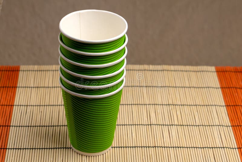 A Stack of Green Paper Cups on a Bamboo Stand Stock Photo - Image of ...
