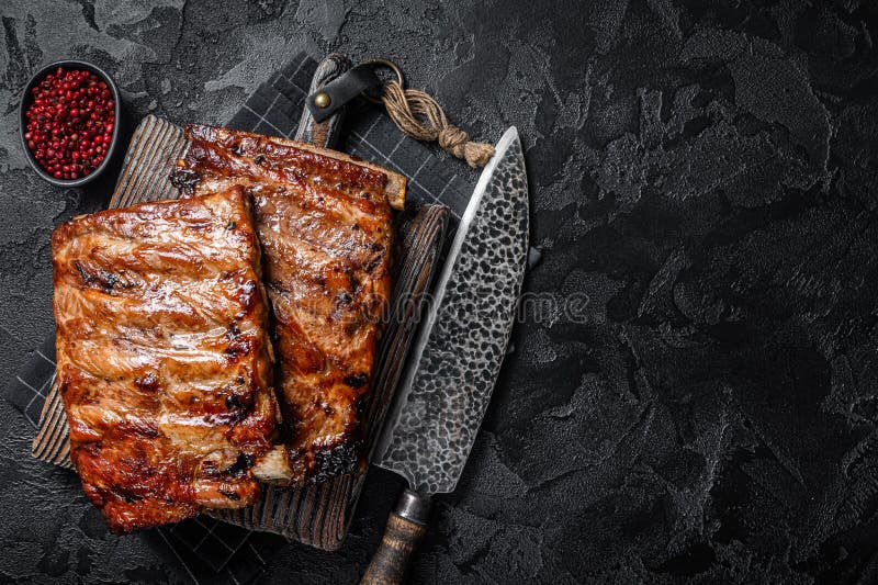 Stack of Grilled Pork Ribs in BBQ Sauce on a Chopping Board. Black ...
