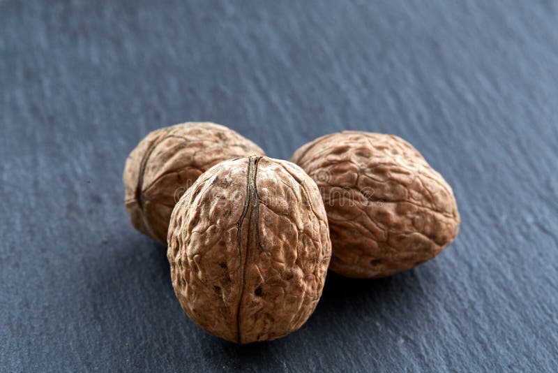 A Stack of Walnuts Piled Together and Isolated on Dark Background ...