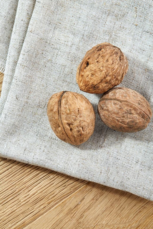 A Stack of Walnuts Piled Together and on Rustic Wooden Background ...