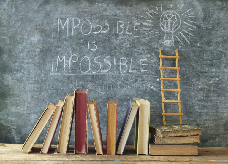 Stack of Hardback Books with Slogan Impossible is Impossible on ...