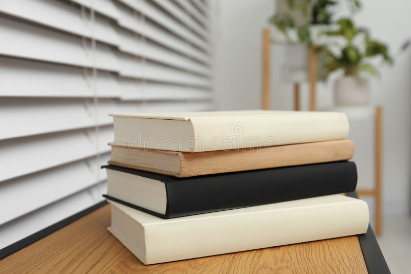 Stack of Hardcover Books on Wooden Table Indoors Stock Image - Image of ...