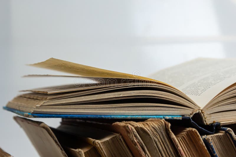Stack of Hardcover Old Books with an Open Book on White Background ...