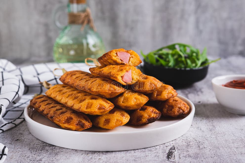 Stack of Homemade Corn Dogs with Sausage on a Plate on a Table Stock ...