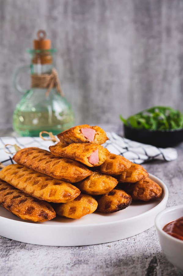 Stack of Homemade Corn Dogs with Sausage on a Plate on a Table Vertical ...
