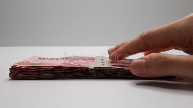 Stack of Indonesian Rupiah Banknotes Patted by Hand Finance Wealth ...