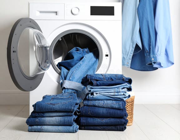 Dirty Jeans in Washing Machine and Other Jeans Clothes Closed. Stock ...