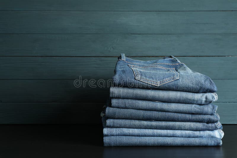 Stack of Jeans Pants on Black Table Stock Image - Image of clothing ...