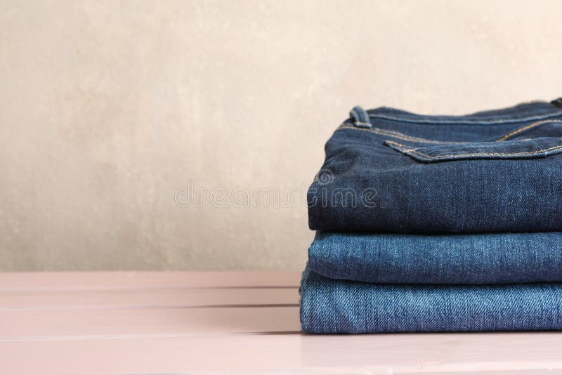Stack of Jeans Pants on Light Pink Background Stock Photo - Image of ...