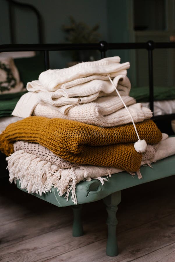 Stack of Knitted Blankets on the Bedside Table in the Bedroom ...