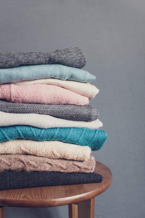 Stack of Knitted Clothes on the Wooden Table Stock Image - Image of ...