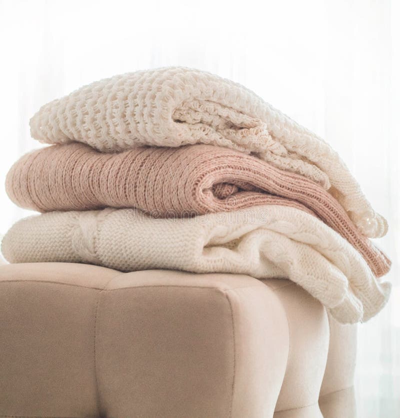 A Stack of Knitted Sweaters in the Interior of the Living Room Stock ...