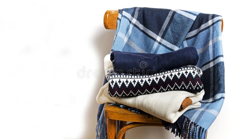 A Stack of Knitted Textured Clothing on a Chair. Warm Knitted Clothes ...