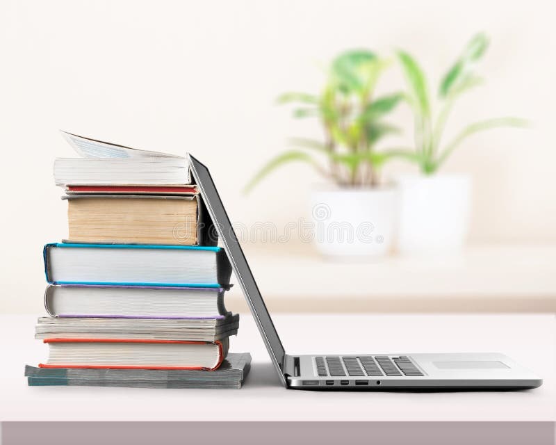 Stack of Books with Laptop on Light Background Stock Photo - Image of ...