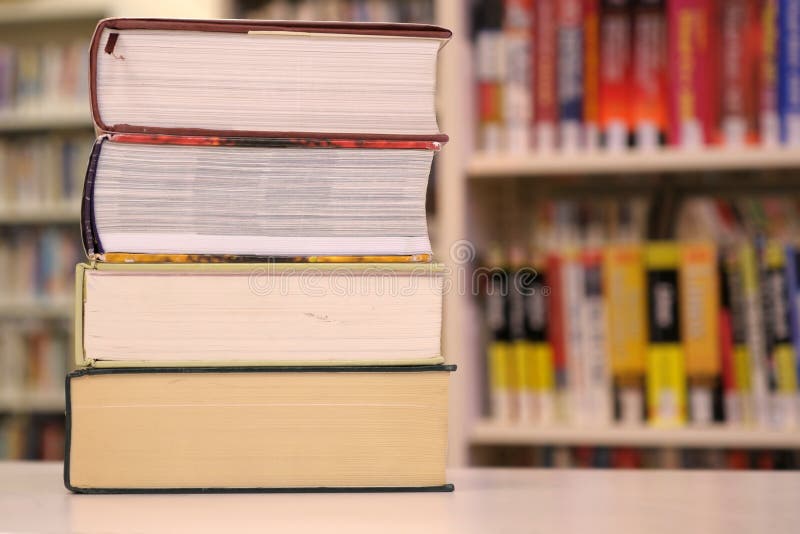 Stack of Large Books and a Library Shelf Stock Image - Image of blurred ...