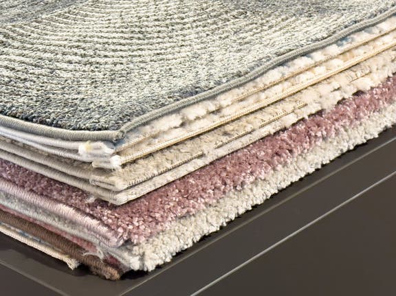 Stack of Layered Textured Carpets with Varied Patterns and Colors for ...