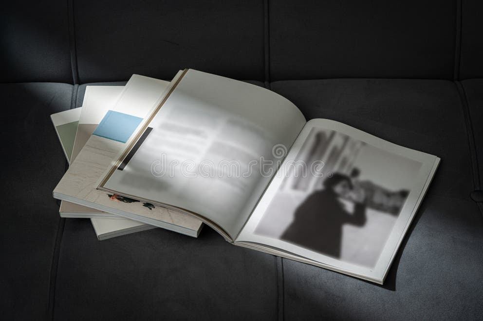 Stack of Magazines on a Black Leather Couch in Soft Light Stock Image ...