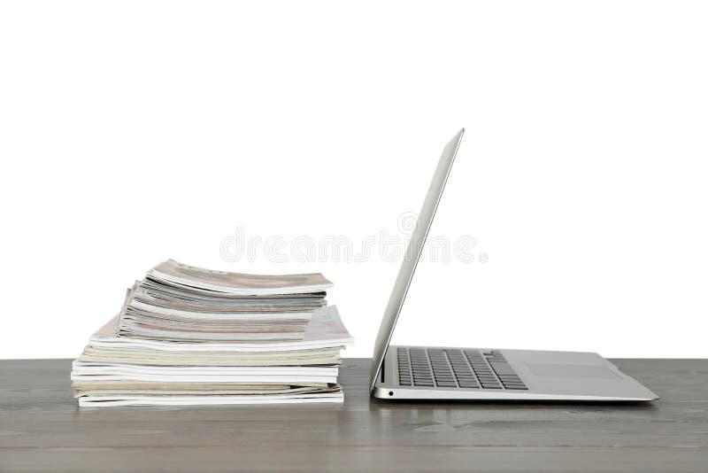 Stack of Magazines and Laptop on Table Near White Wall Stock Photo ...