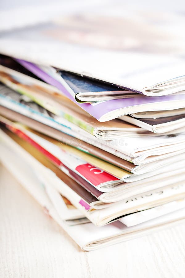 Stack of Magazines on White Table Stock Photo - Image of print ...