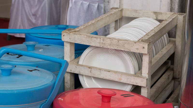 Stack of Many White Plates in Wooden Rack. Stack of Dishes in Wooden ...