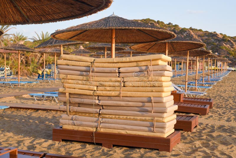 Stack of Mattresses with Thatched Umbrellas on the Beach. Stock Image ...