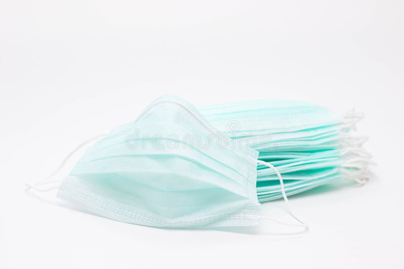 A Stack of Medical Face Masks on a White Background. Article about the ...