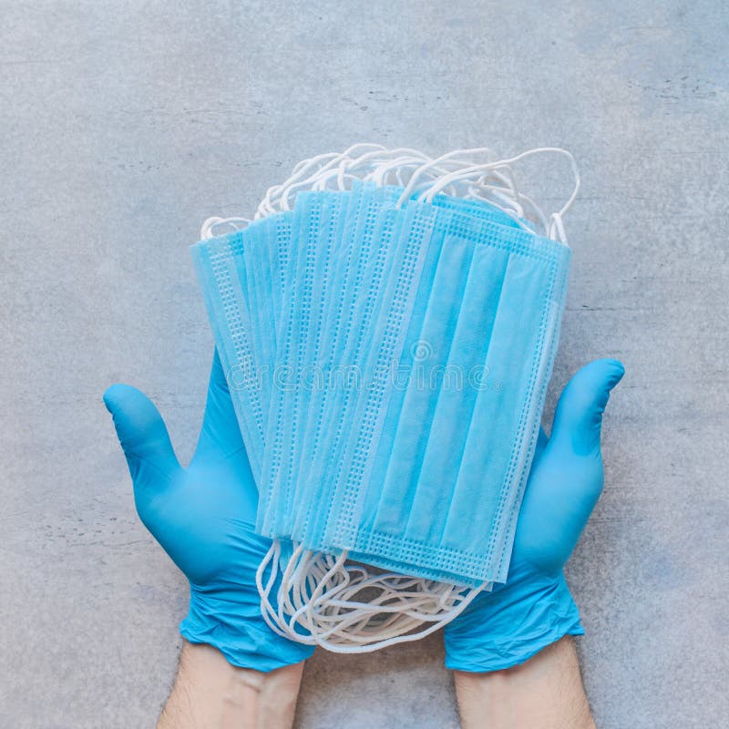 Stack of Medical Masks Held by Male Hands in Medical Gloves Stock Photo ...