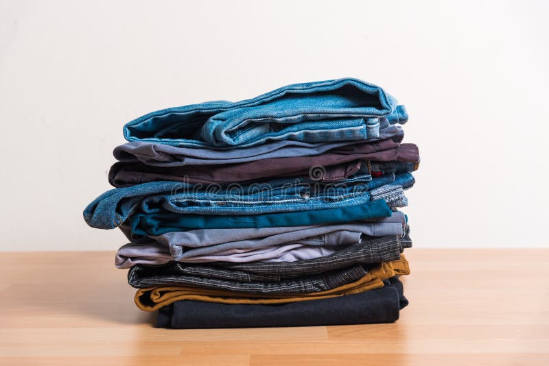 Stack of Men Pants on Wood Table Stock Photo - Image of fashion, stack ...