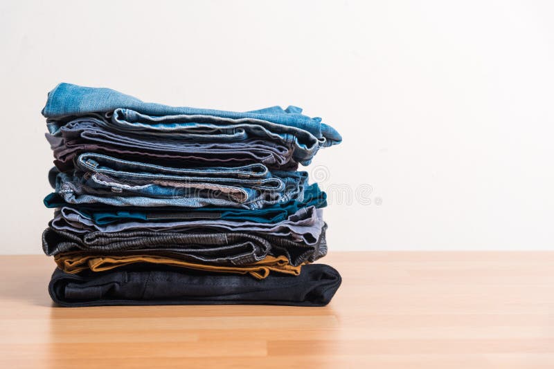 Stack of Men Pants on Wood Table Stock Image - Image of white, pants ...