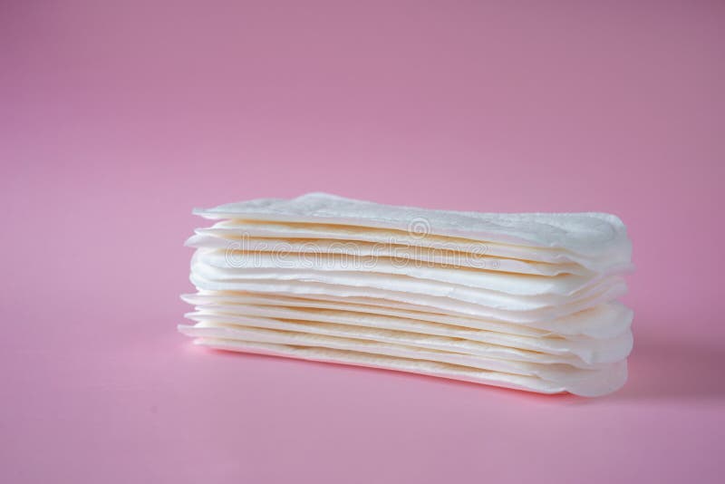 Stack of Menstrual Pads with Red Rose and Tampons on Grey Background ...