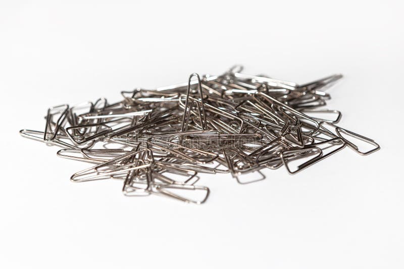 Stack of Metal Clips on a White Surface Stock Image - Image of metallic ...