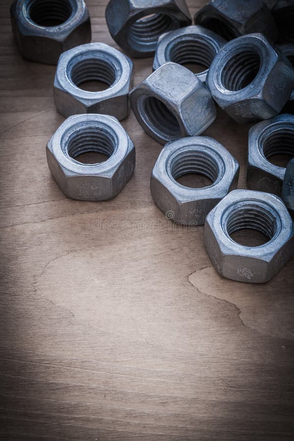 Stack of Metal Threaded Screw-nuts on Vintage Wooden Board Stock Photo ...