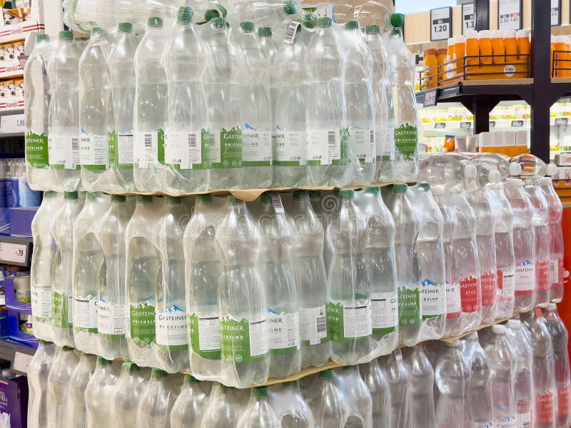 Stack of Mineral Water Bottles on Pallets in Supermarket Aisle ...
